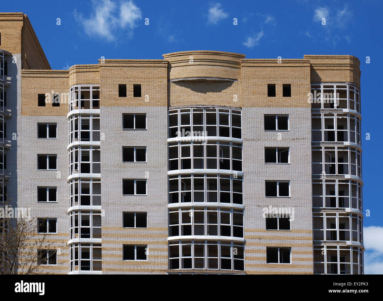 The upper floors of multistory building against the blue sky with ...