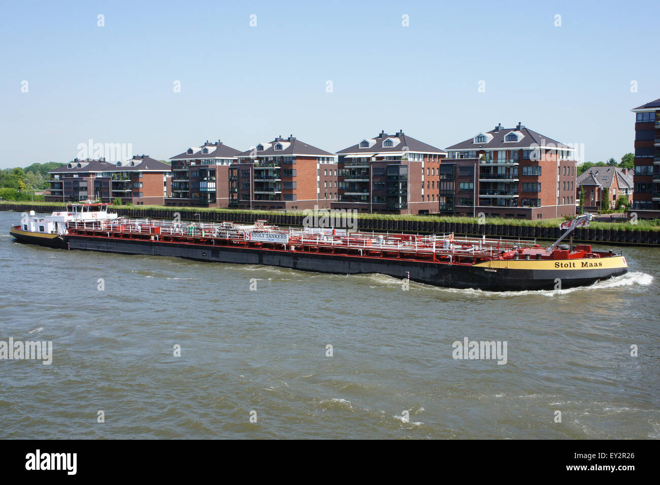This image captures a container ship and chemical tanker navigating the ...