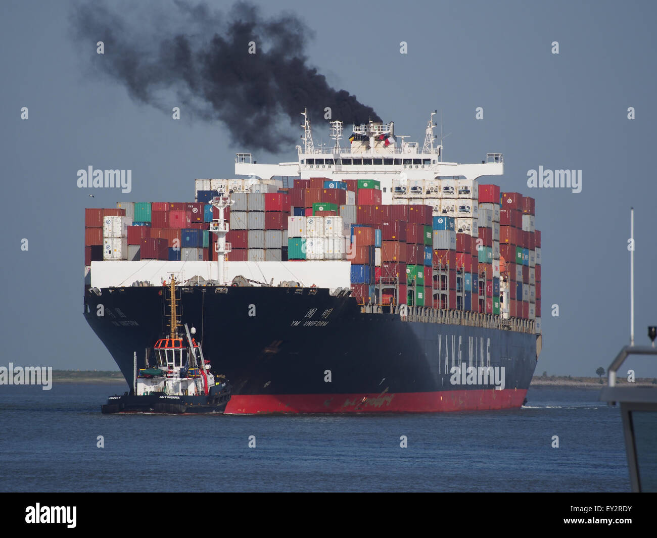 This photograph captures the YM Uniform, a container ship with IMO ...