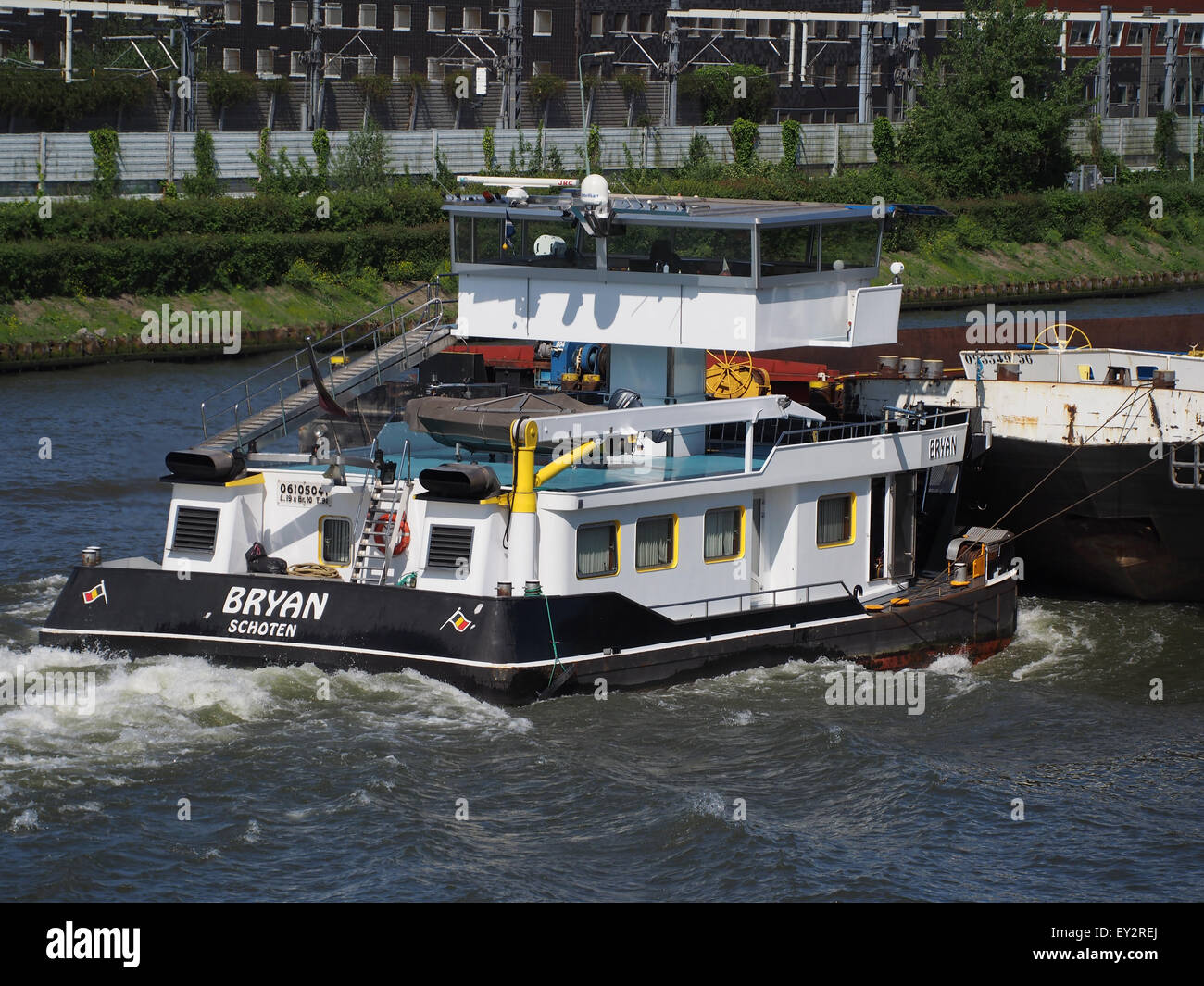 This photograph showcases a large freight barge, the Slinge, being ...