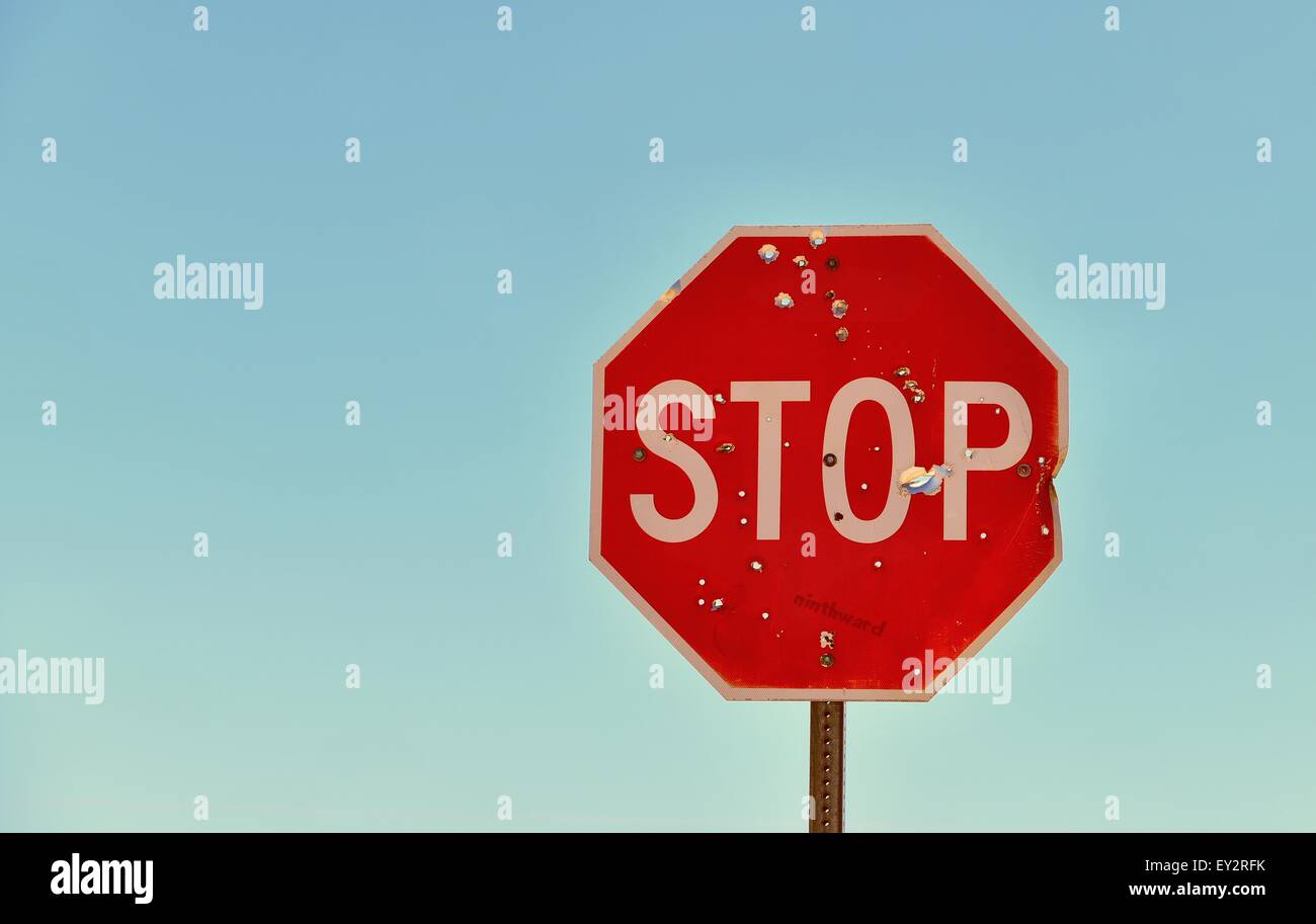 Stop sign with bullet holes Stock Photo - Alamy