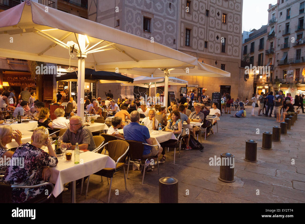People eating outdoors at night at a restaurant in the Ribera district ...