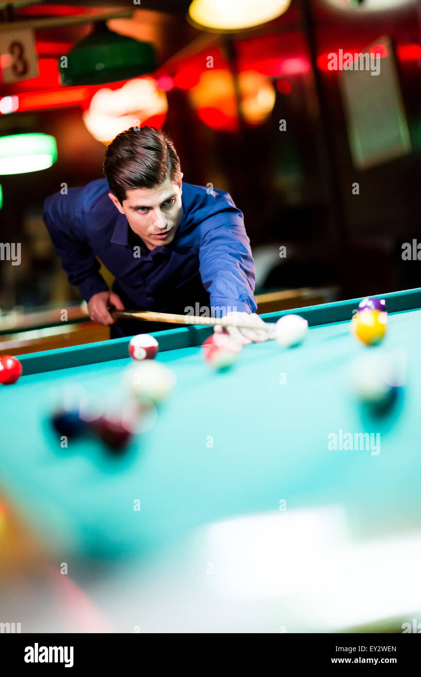 Young man playing pool Stock Photo - Alamy