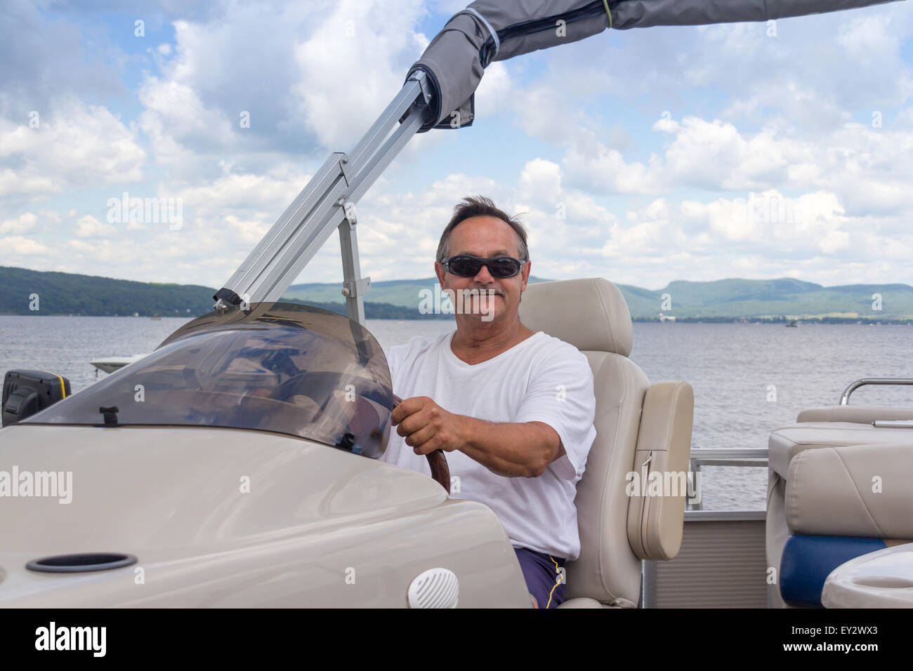 Caucasian male driving boat hi-res stock photography and images - Alamy