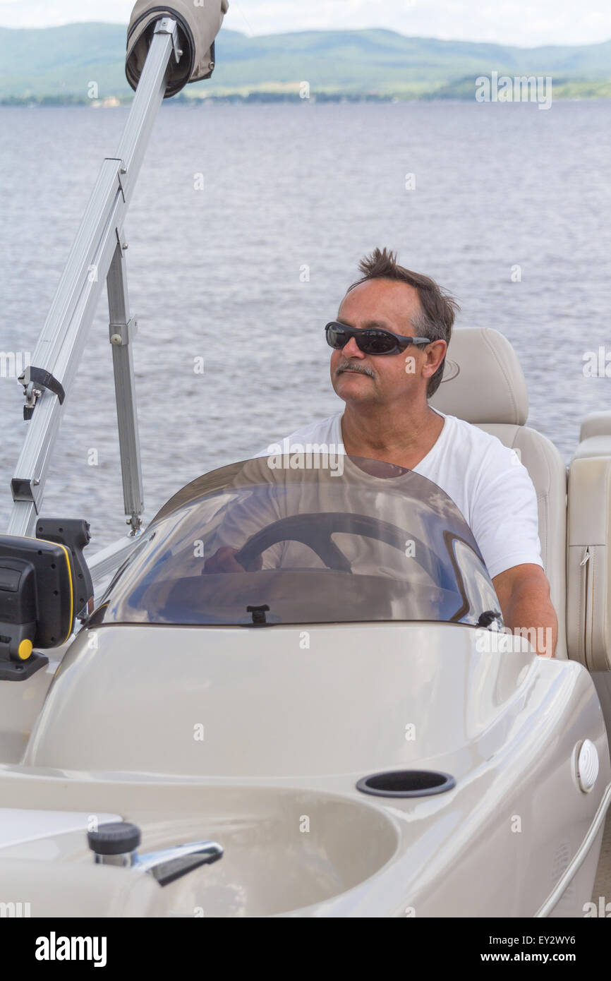 Caucasian male driving boat hi-res stock photography and images - Alamy