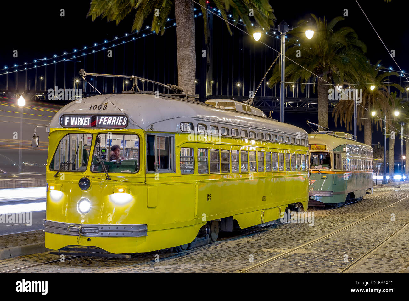 Night shot of a Yellow vintage streetcar running the F Line, parked at ...