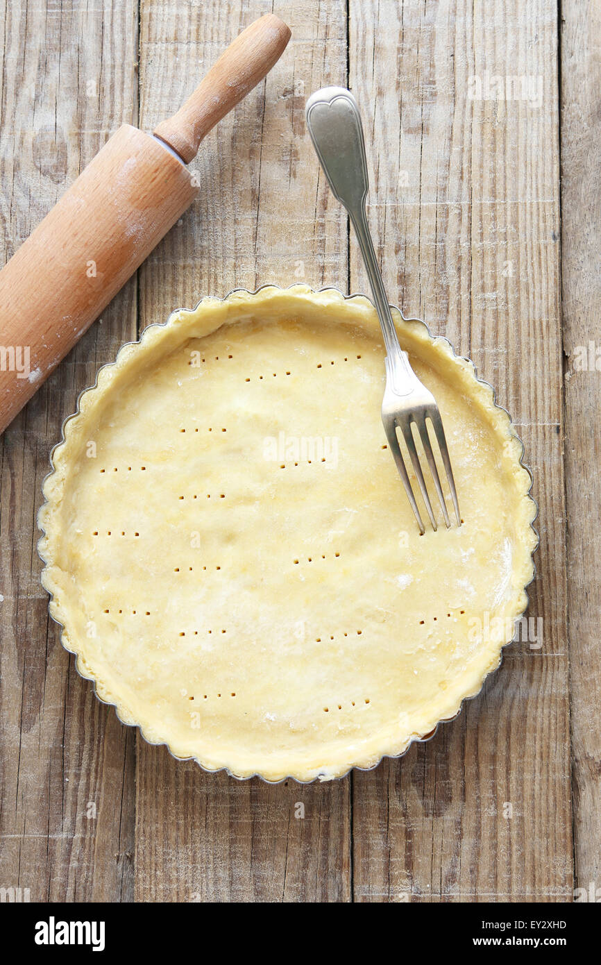 Tart dish with pastry base before being filled to be baked.Top view ...
