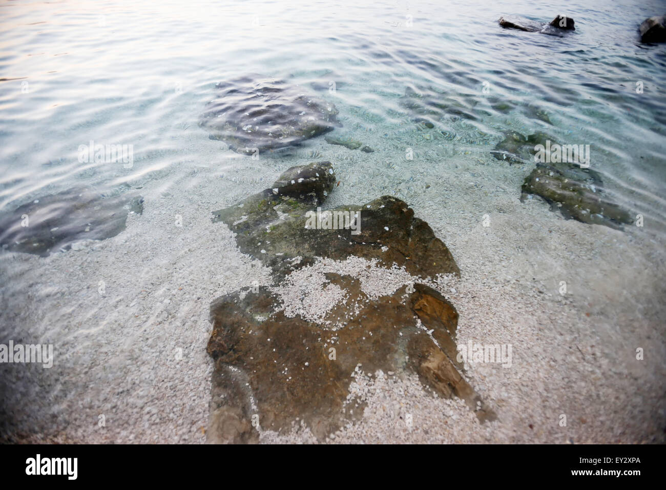 A high angle view of the sea water surface on the beach at sunset Stock ...