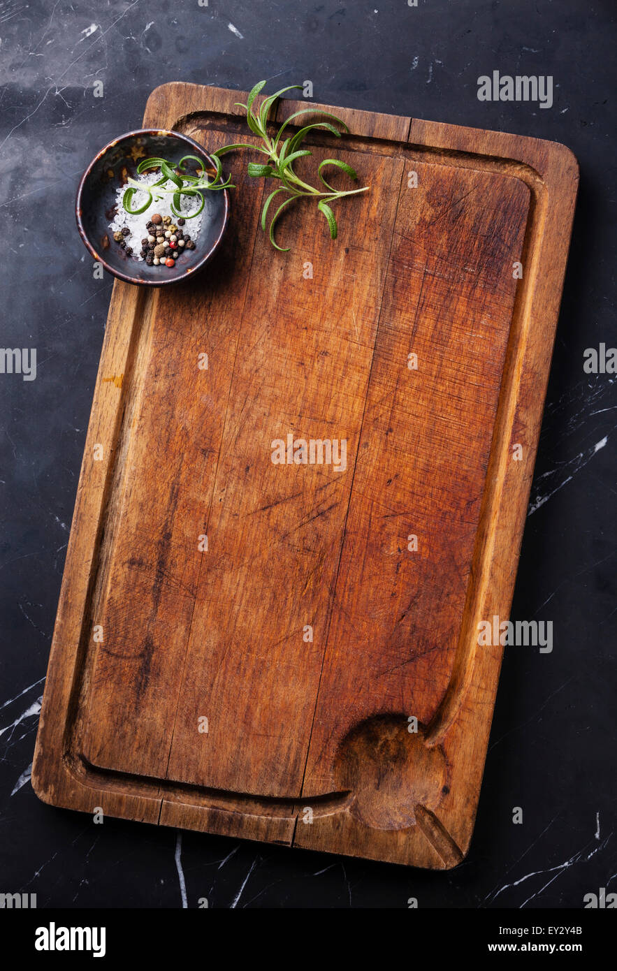 Chopping cutting board, seasonings and rosemary on dark marble background Stock Photo - Alamy