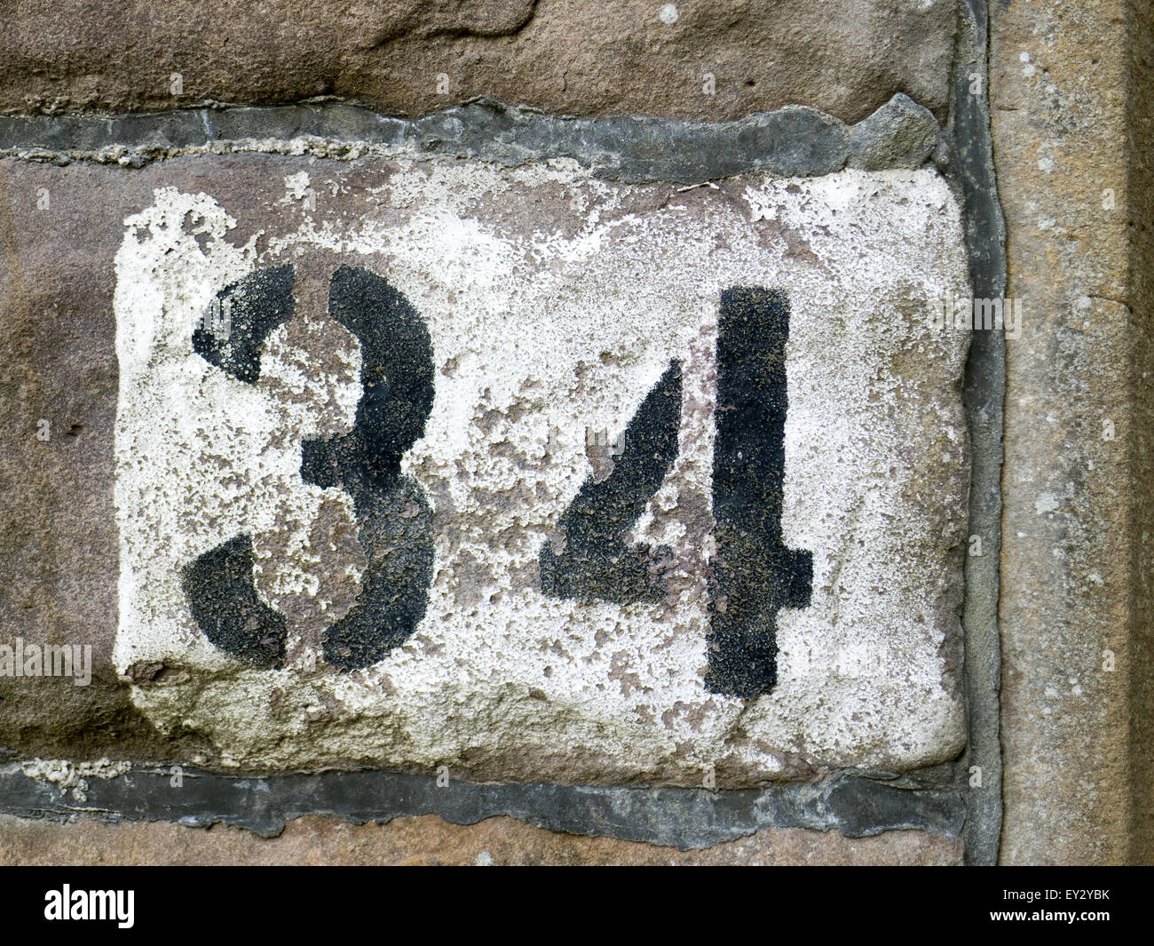 Number 34 painted on stone Stock Photo - Alamy