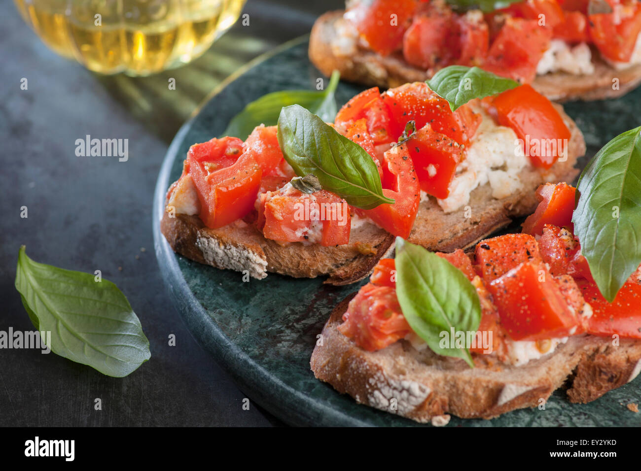 Italian tomato bruschetta with basil and olive oil on crusty slice of ...