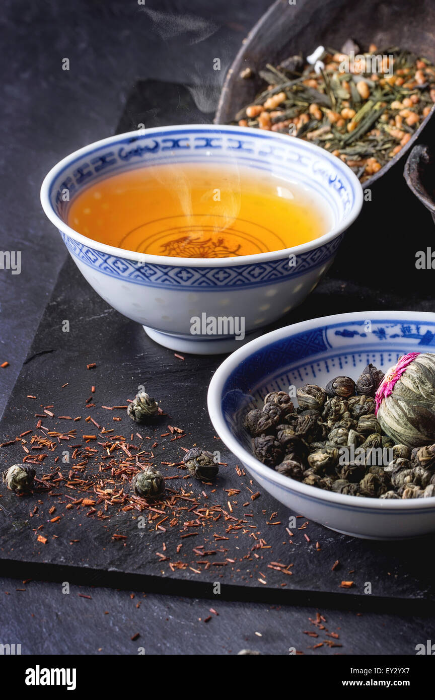 Assortment of dry tea and cup of hot tea. Green tea, black tae, green ...