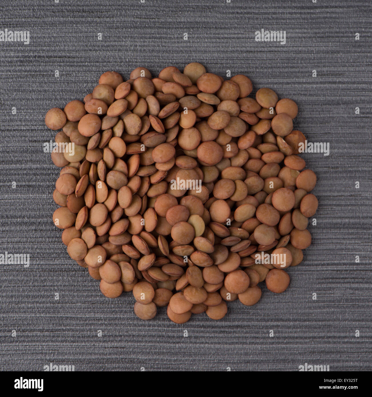 Top view of circle of lentils against grey vinyl background Stock Photo ...