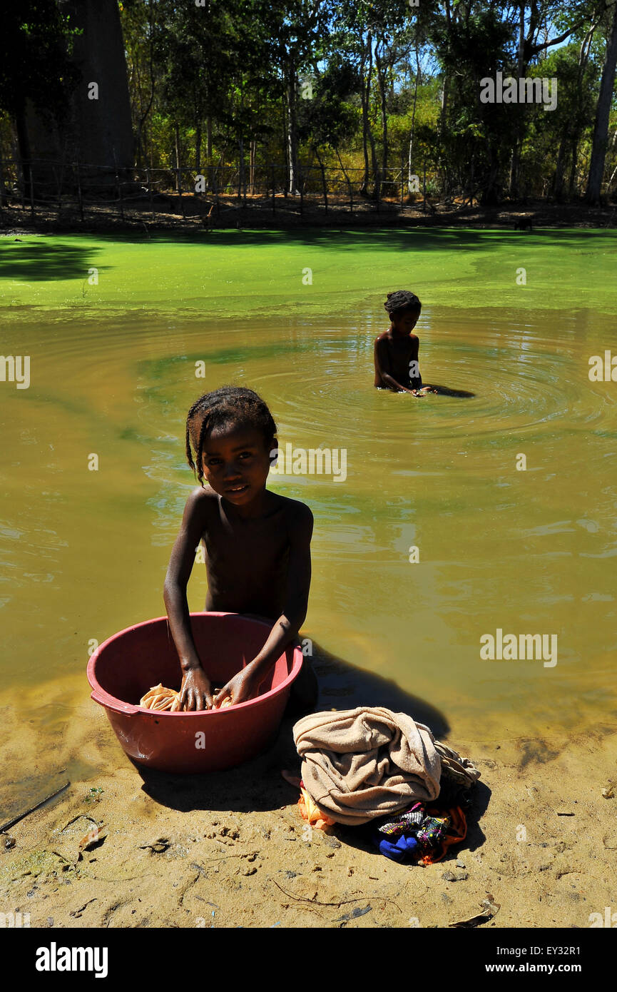 Malagasy girls washing clothes in a pond in Madagascar Stock Photo - Alamy