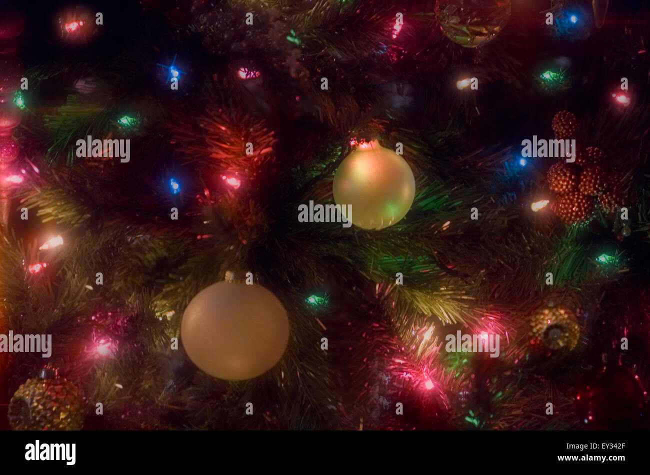 Horizontal image of ornaments on a Christmas tree with lights. With ...