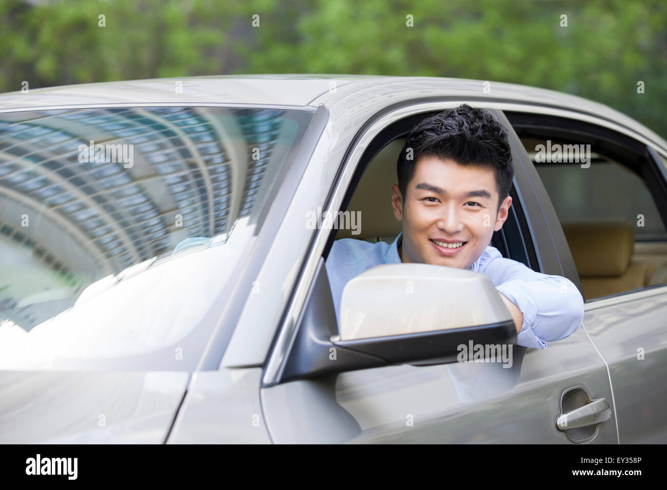 Young man driving car Stock Photo - Alamy