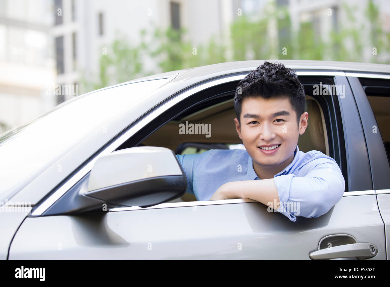 Young man driving car Stock Photo - Alamy