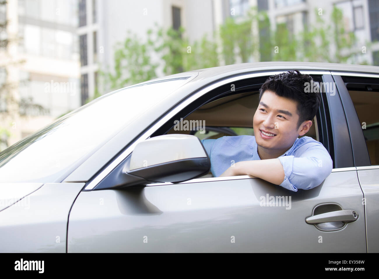 Young man driving car Stock Photo - Alamy