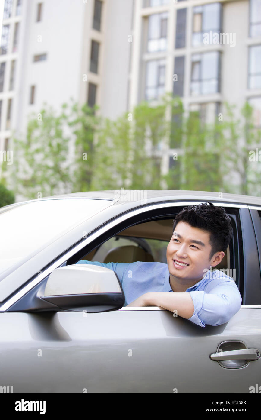 Young man driving car Stock Photo - Alamy