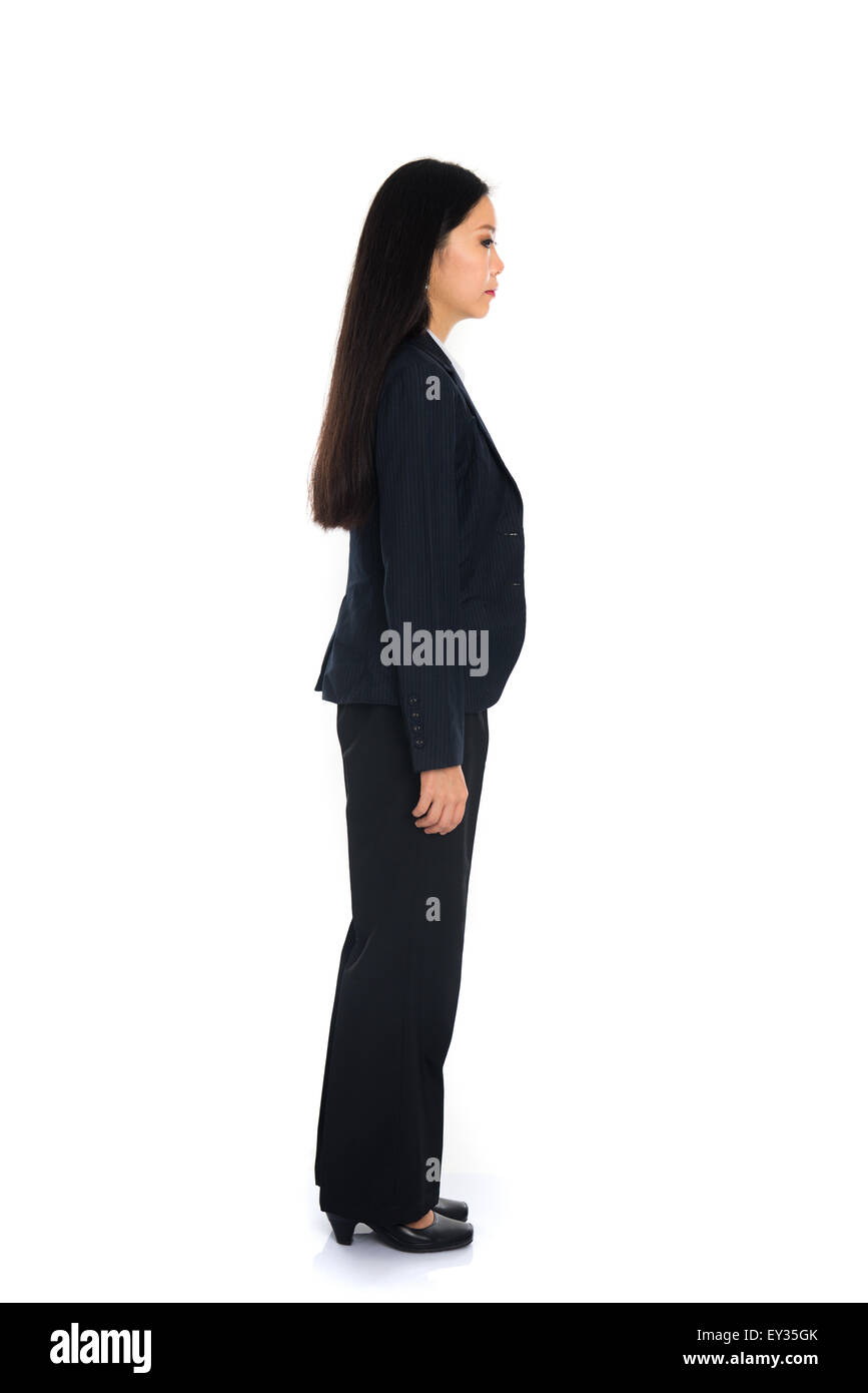 Side view of Asian business woman thinking, full length portrait ...