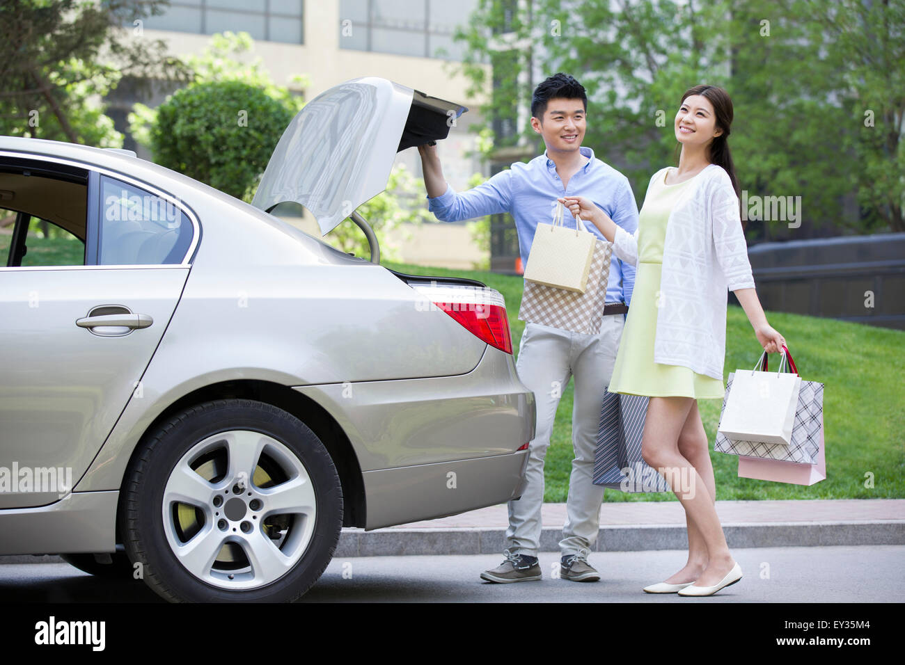 Young couple coming back from shopping Stock Photo - Alamy