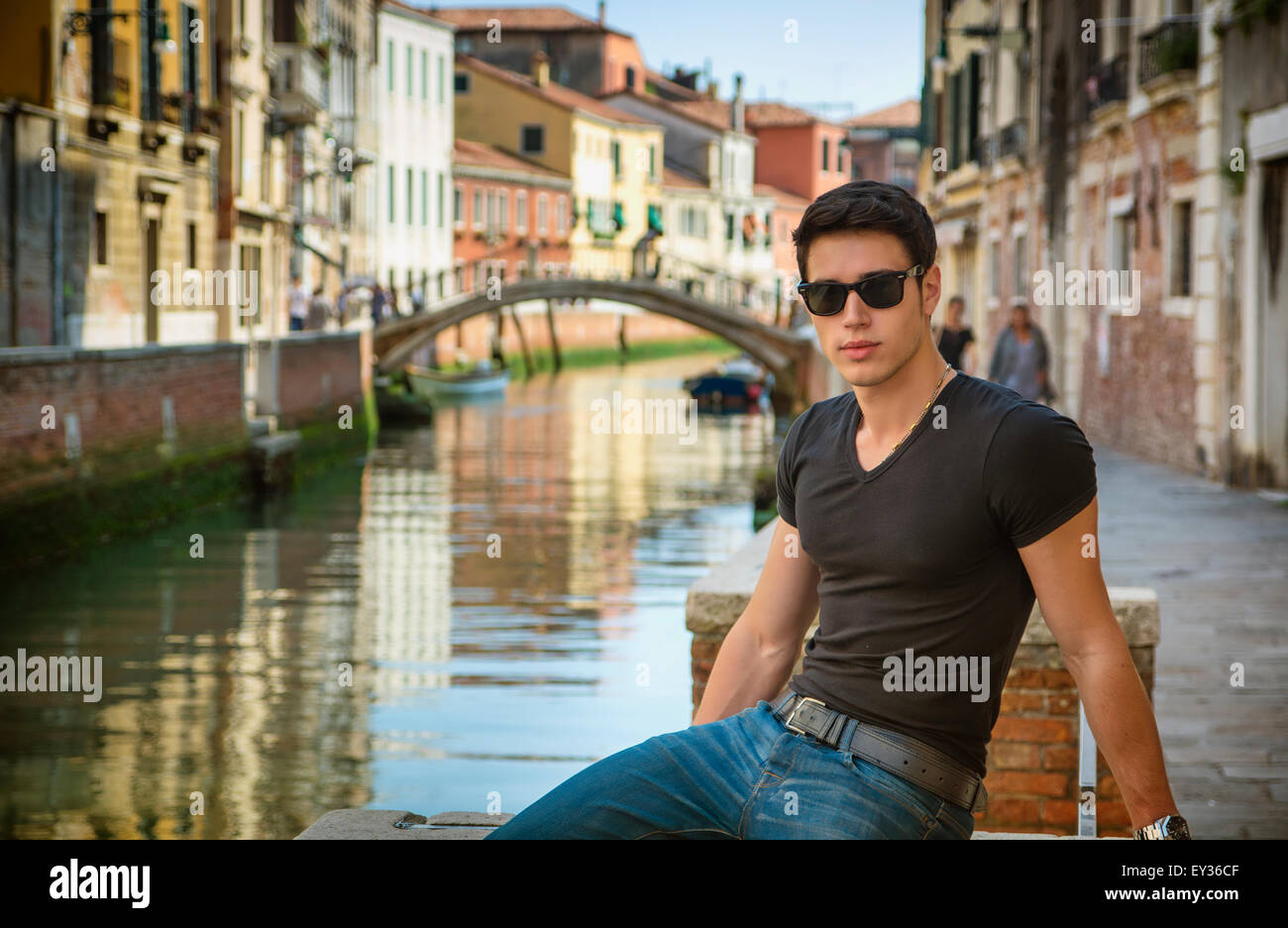 Portrait of Attractive Dark Haired Young Man Leaning Against Railing on ...