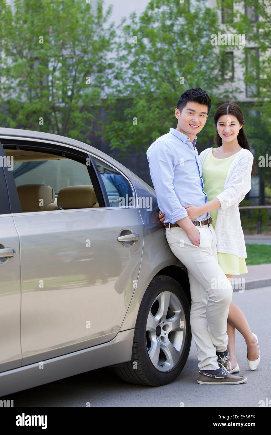 Happy young couple and car Stock Photo - Alamy