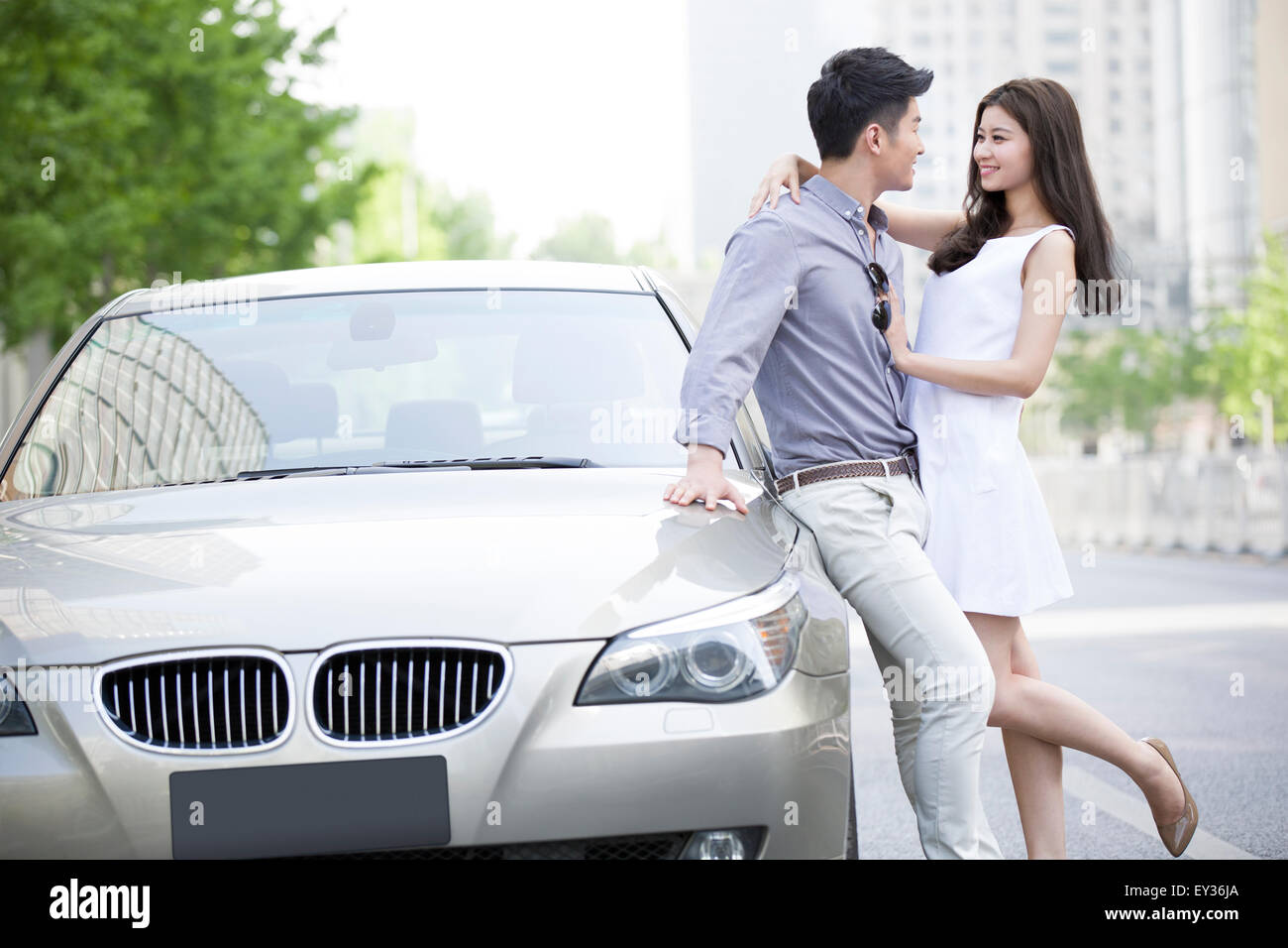 Happy young couple and car Stock Photo - Alamy