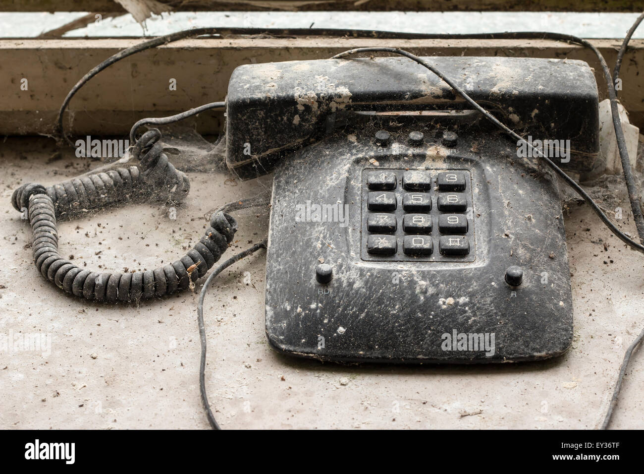 Old disused phone overgrown with cobwebs Stock Photo - Alamy