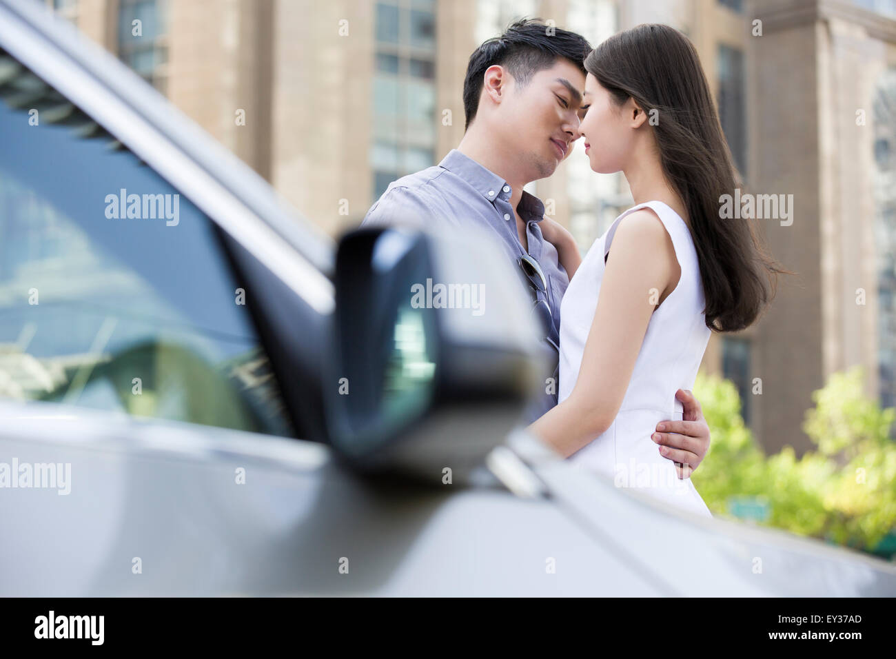 Young couple kissing next to their car Stock Photo - Alamy