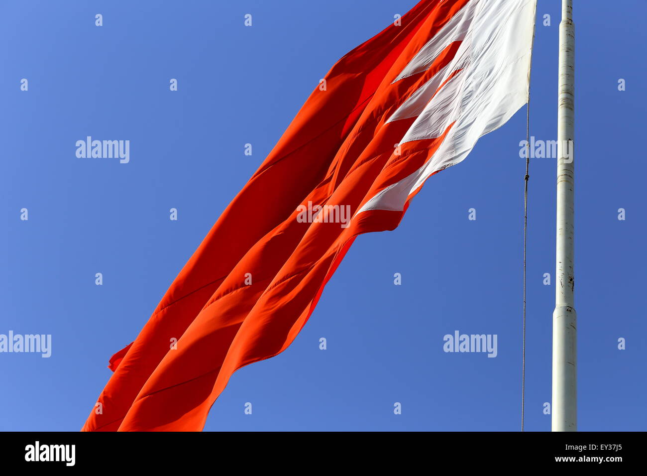 Bahrain flag blowing in the wind on a sunny day Stock Photo - Alamy