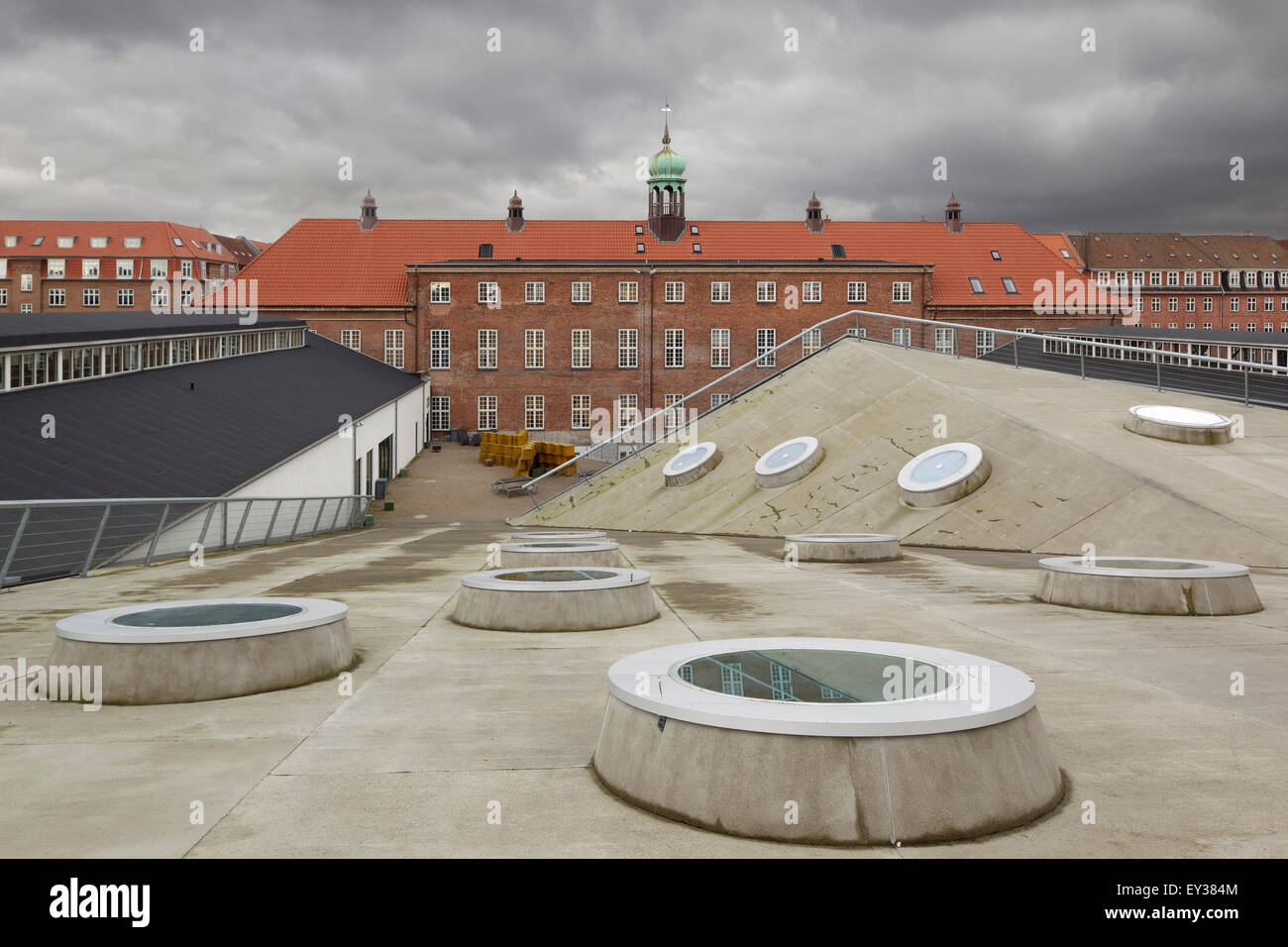 Circular lightwells on sloping concrete roof with original main ...