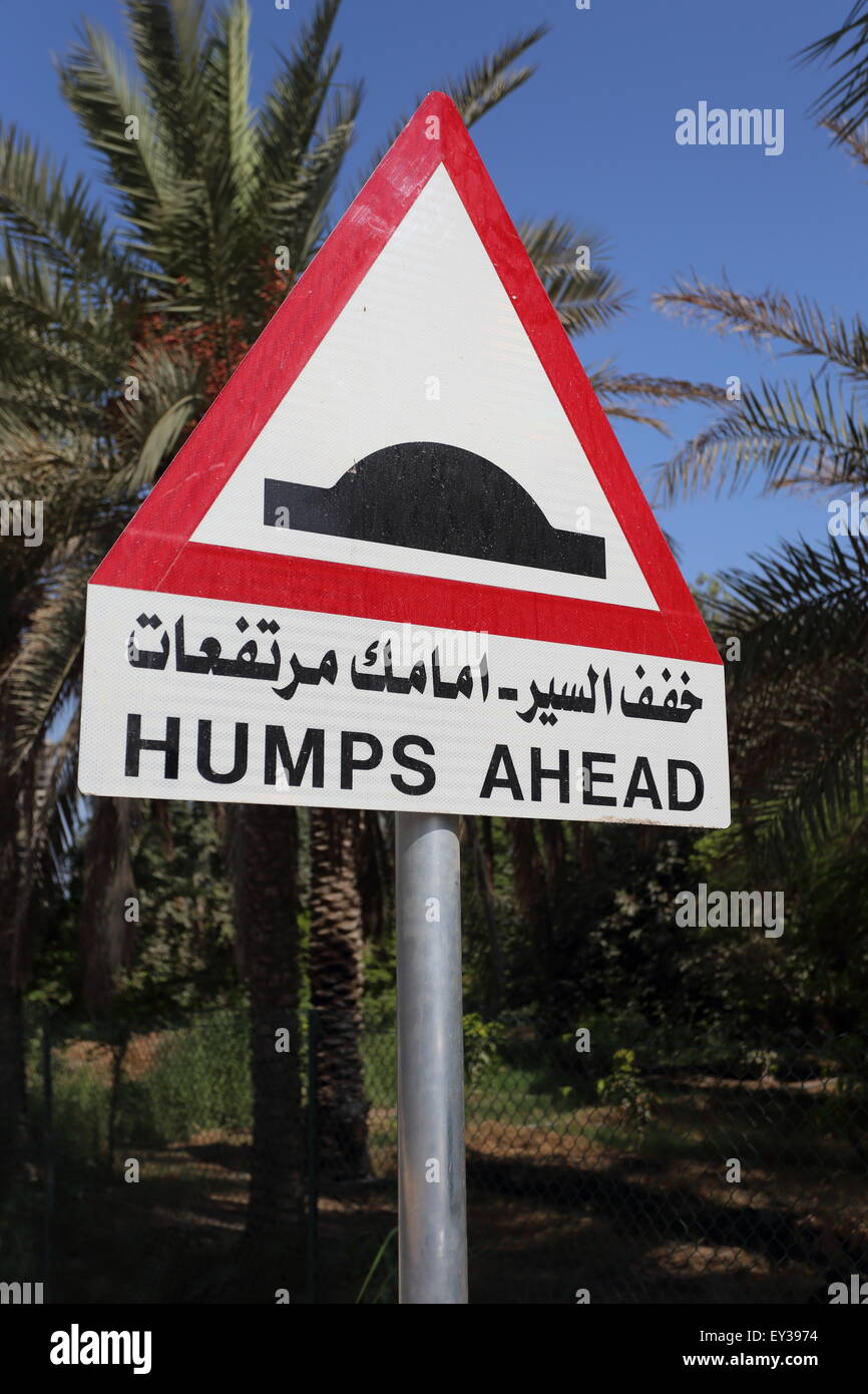 A road sign in Arabic and English warning motorists of speed humps ...