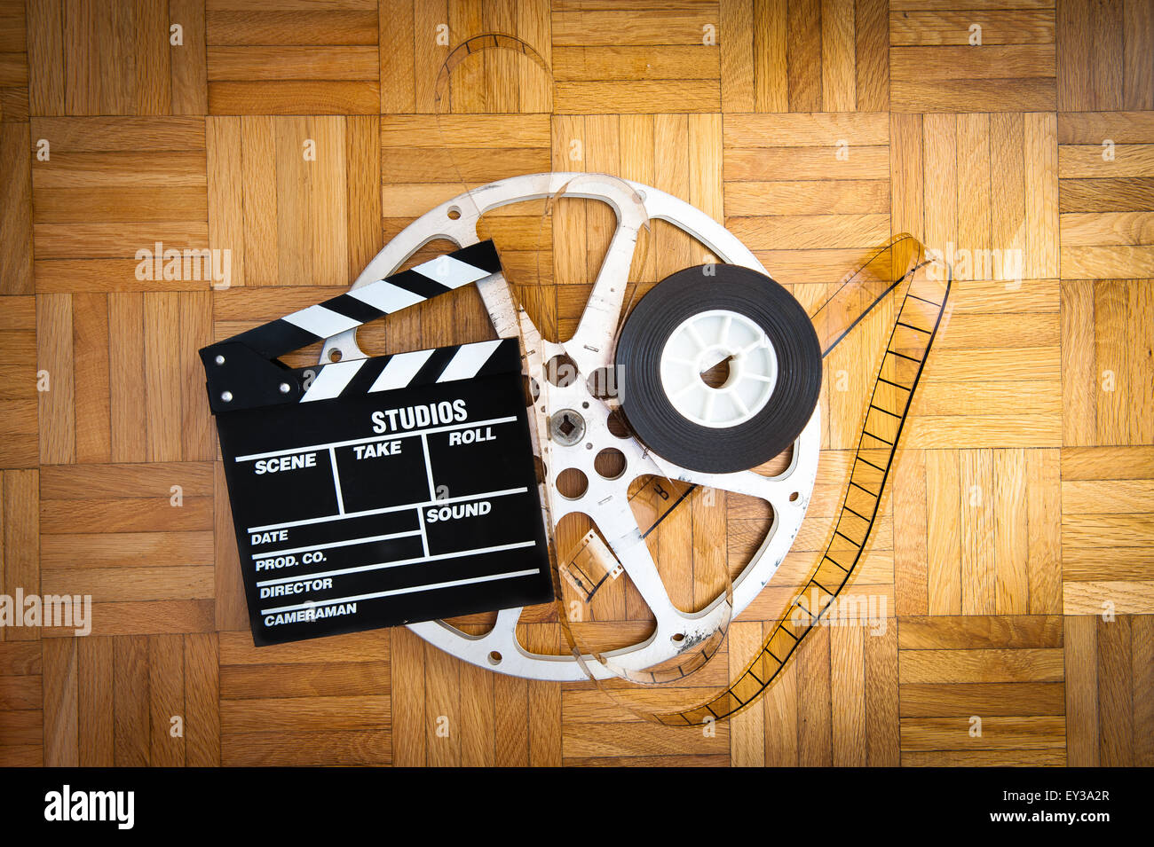 Cinema movie clapper board with 35 mm filmstrip and reel on wooden ...
