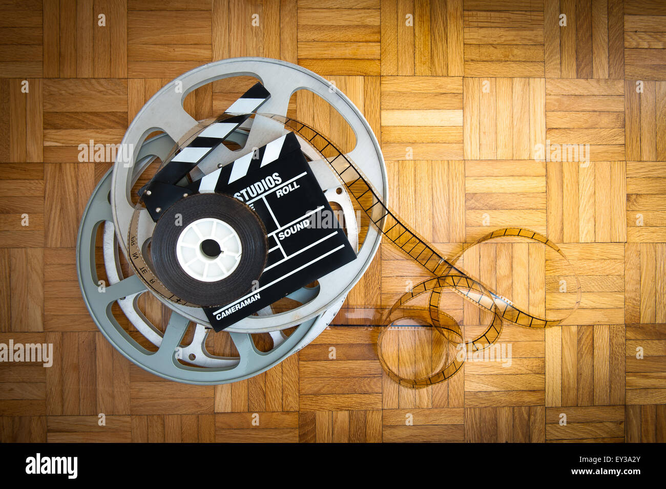 Cinema movie clapper board with 35 mm filmstrip and reel on wooden ...