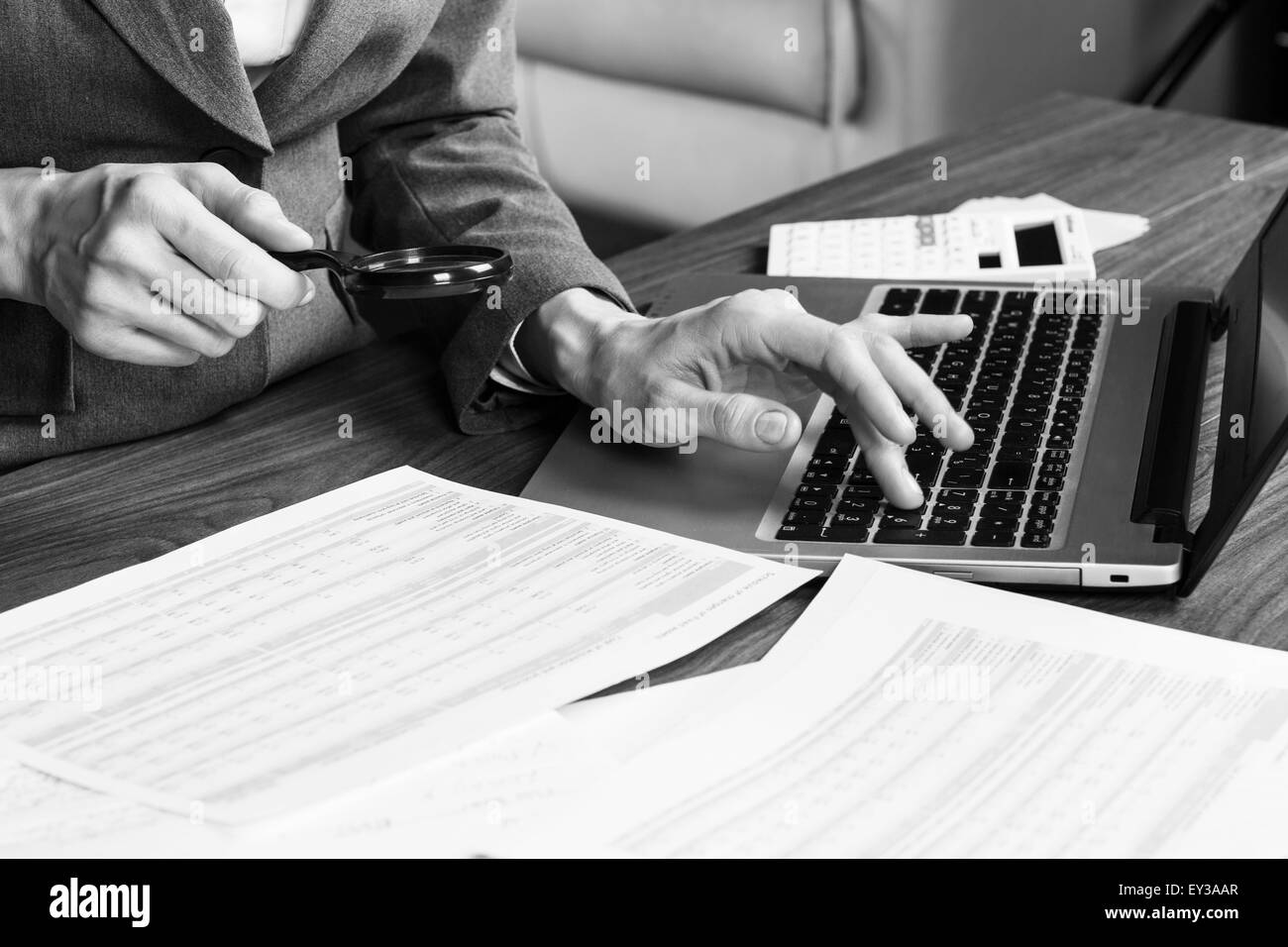 Calculating on calculator Black and White Stock Photos & Images - Alamy