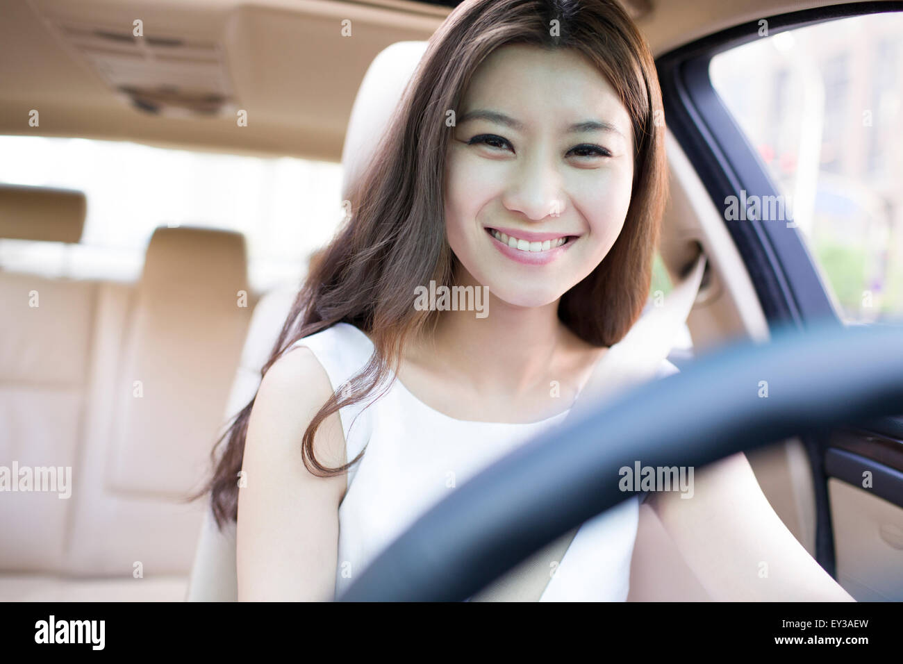 Young woman driving car Stock Photo - Alamy