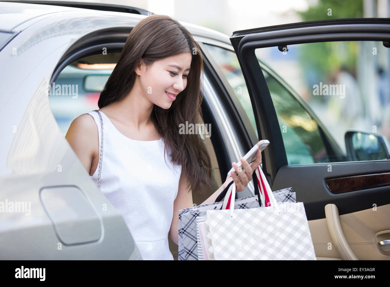 Woman getting out car holding hi-res stock photography and images - Alamy