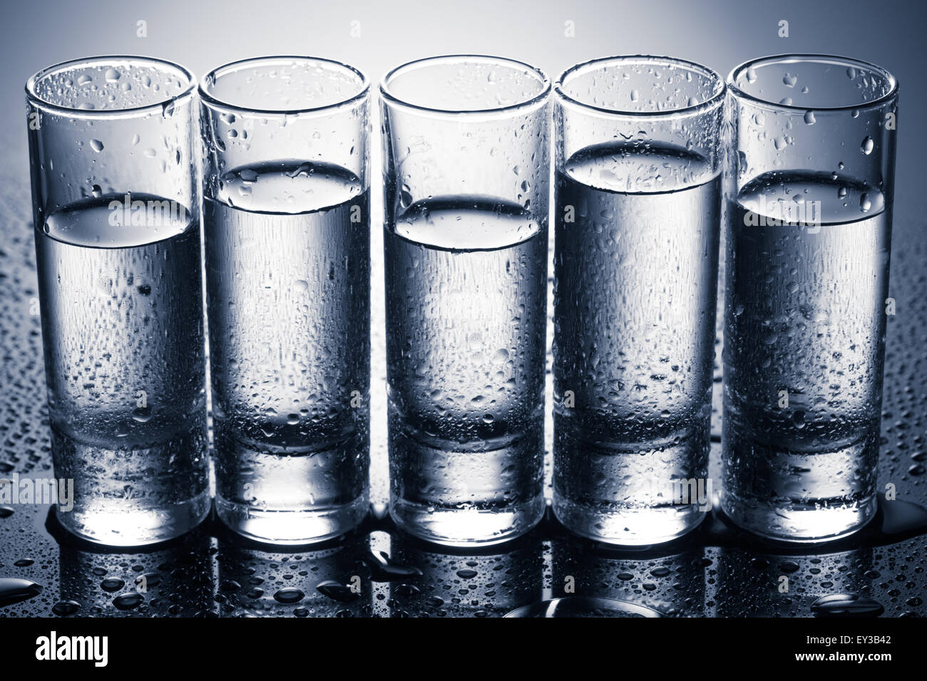 row of glasses for vodka Stock Photo - Alamy