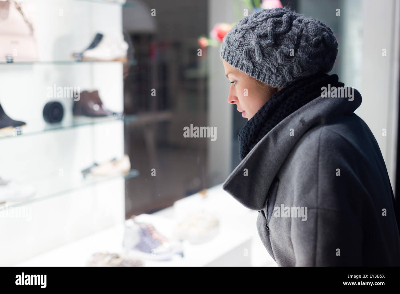 Woman window shopping Stock Photo - Alamy