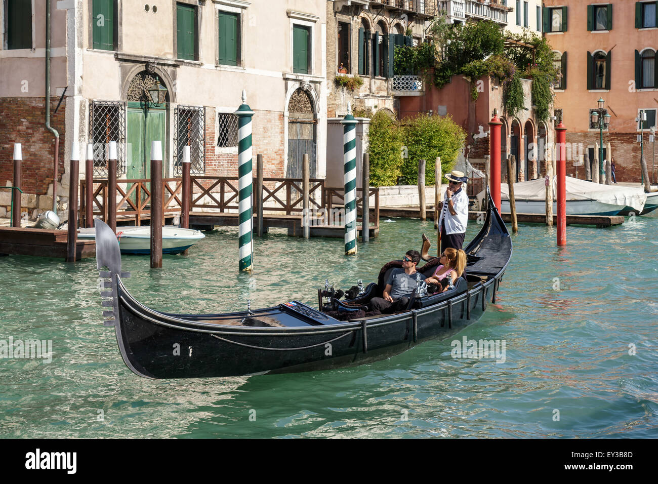 Gondolier ferrying people in Venice Stock Photo - Alamy