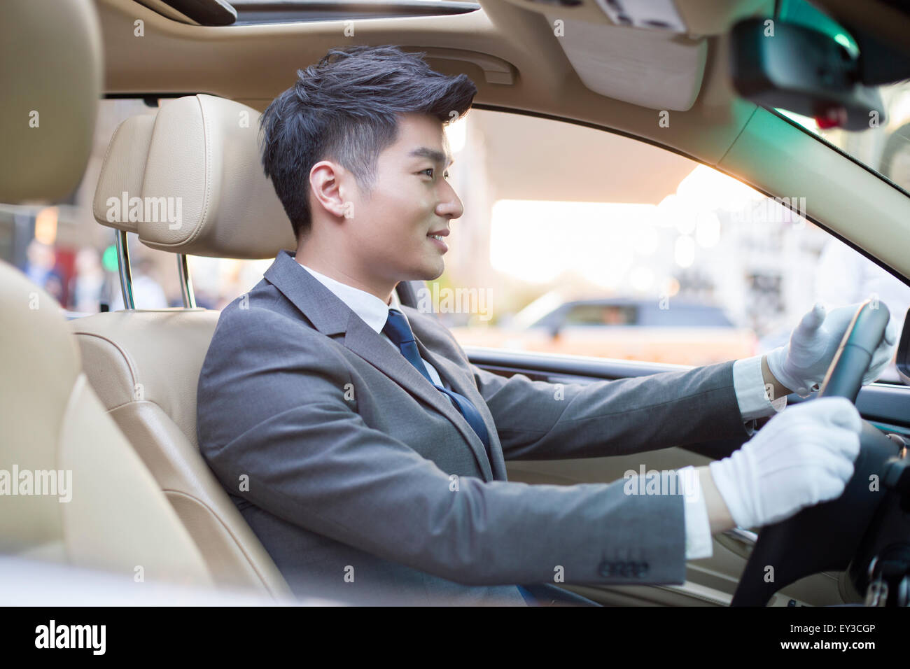 Chauffeur driving car Stock Photo - Alamy