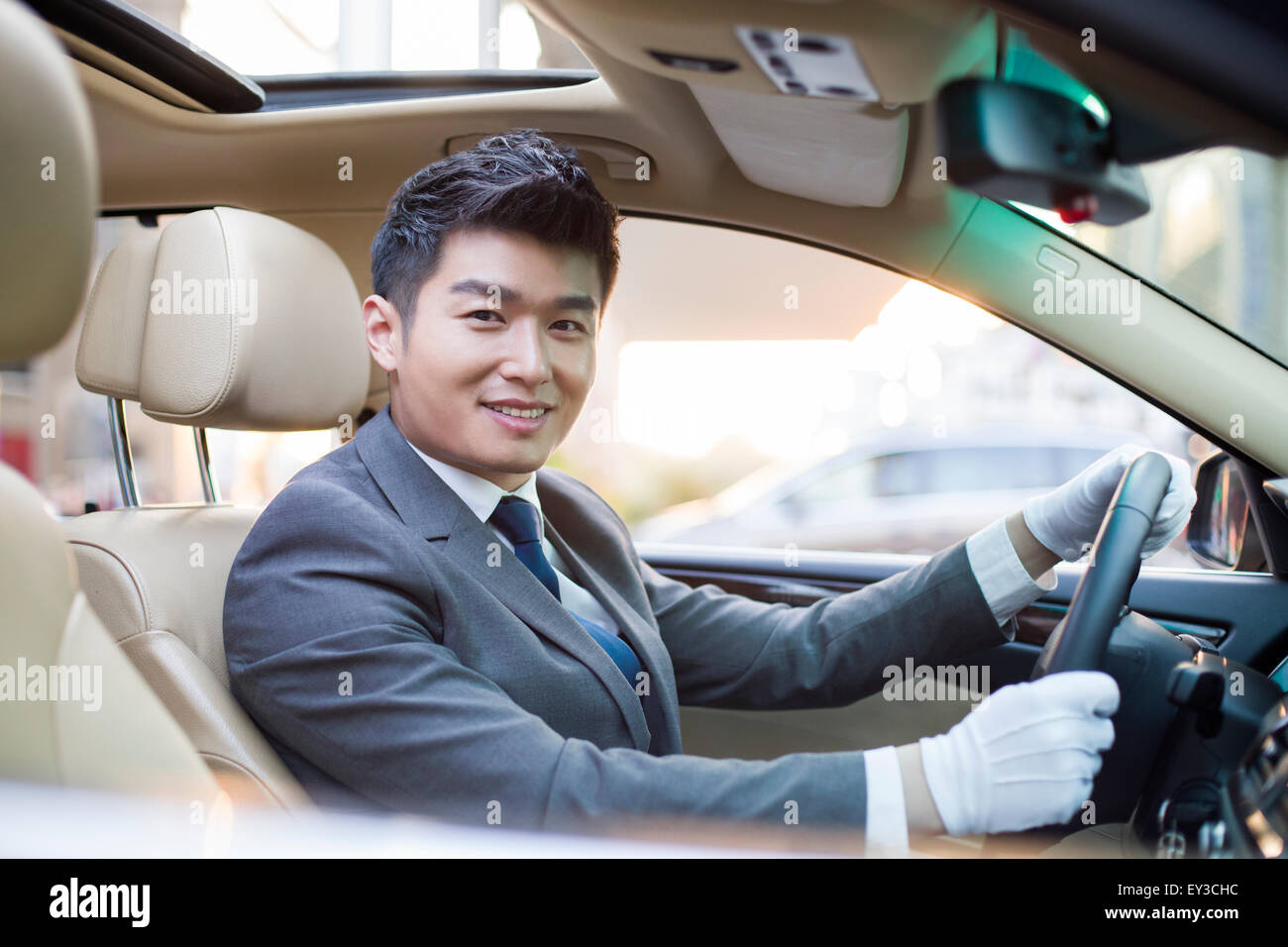 Chauffeur driving car Stock Photo - Alamy