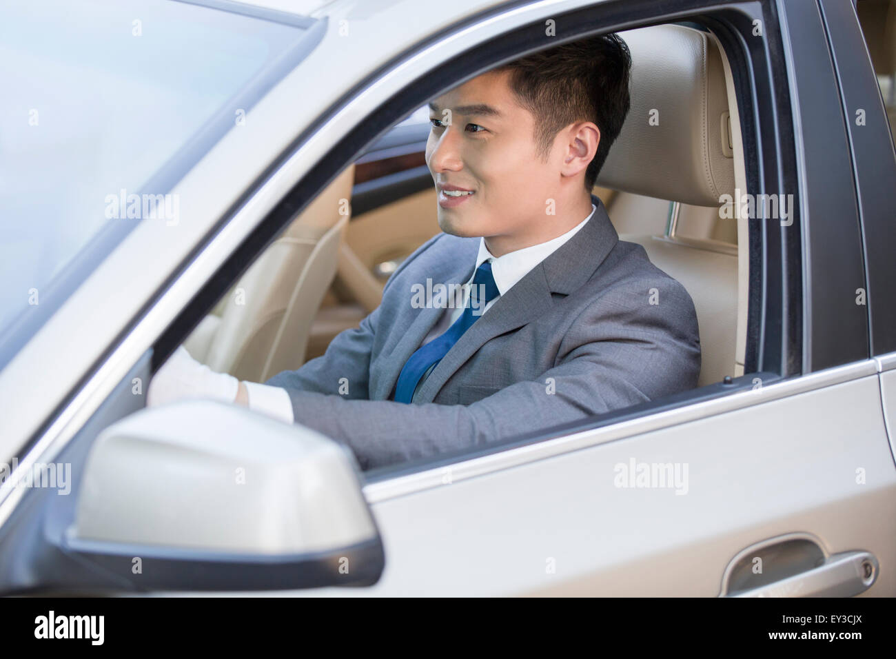 Chauffeur driving car Stock Photo - Alamy