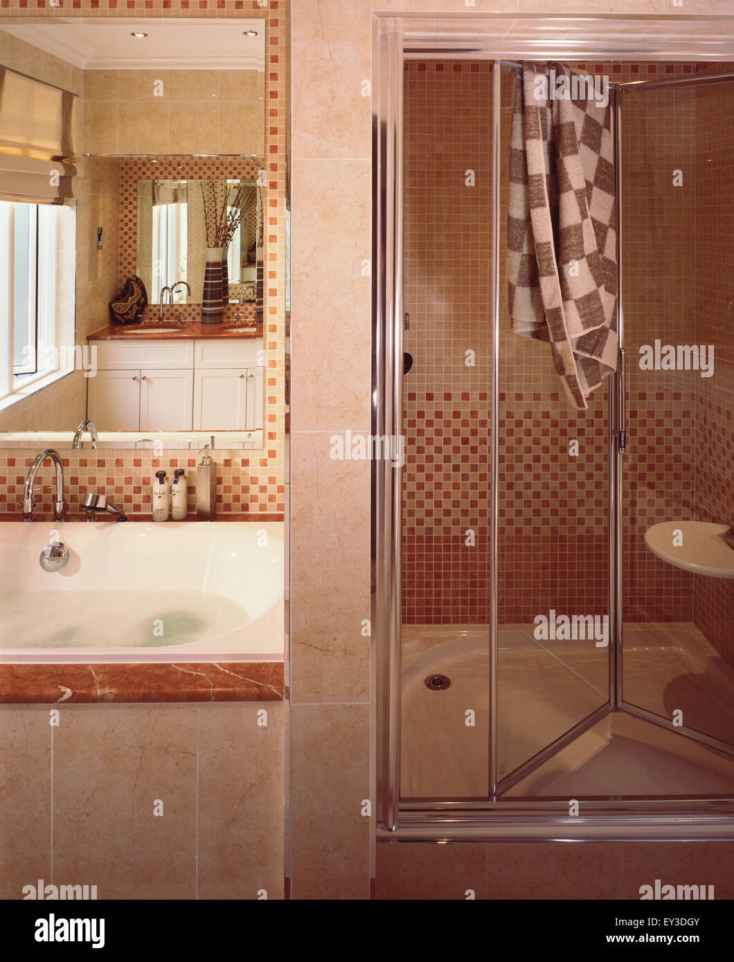 A tiny bathroom in a newly built flat showing shower, basin and bath ...