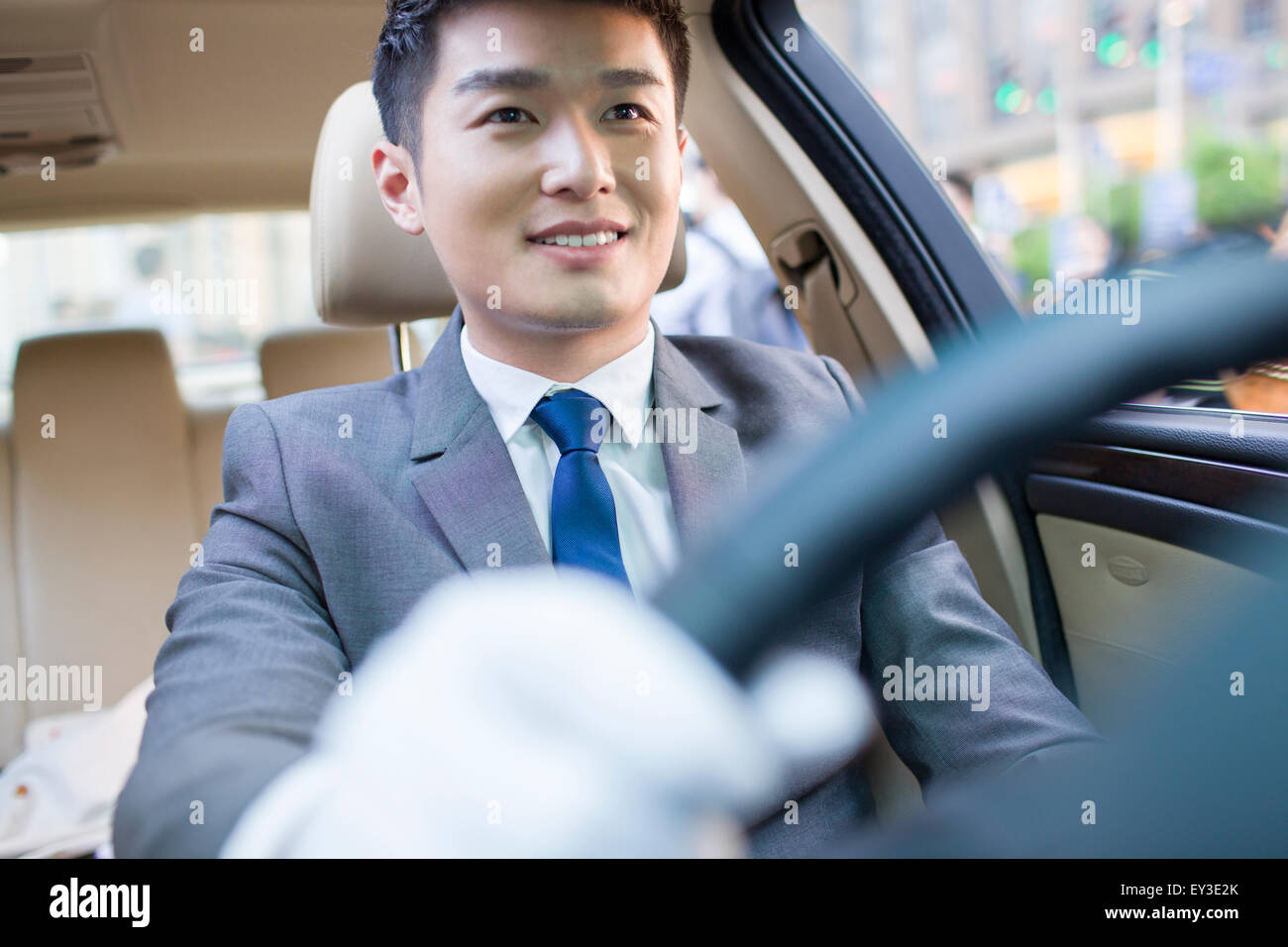 Chauffeur driving car Stock Photo - Alamy