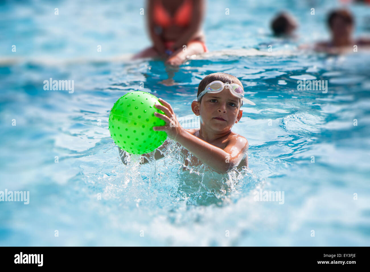 Playing ball swimming pool hi-res stock photography and images - Alamy