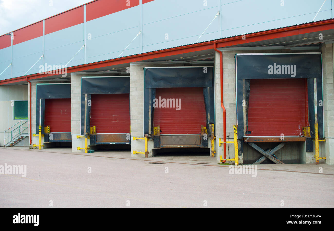 Warehouse with four red sliding gates Stock Photo - Alamy