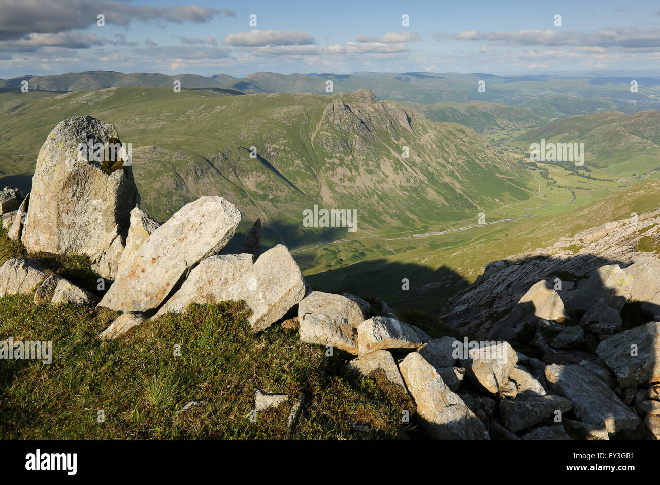 Bowfell rocky summit . Summer evening on Bowfell looking to the great ...
