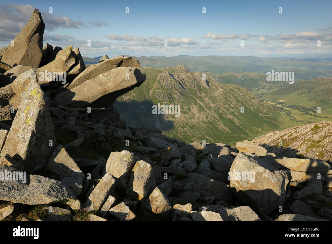 Bowfell rocky summit . Summer evening on Bowfell looking to the great ...